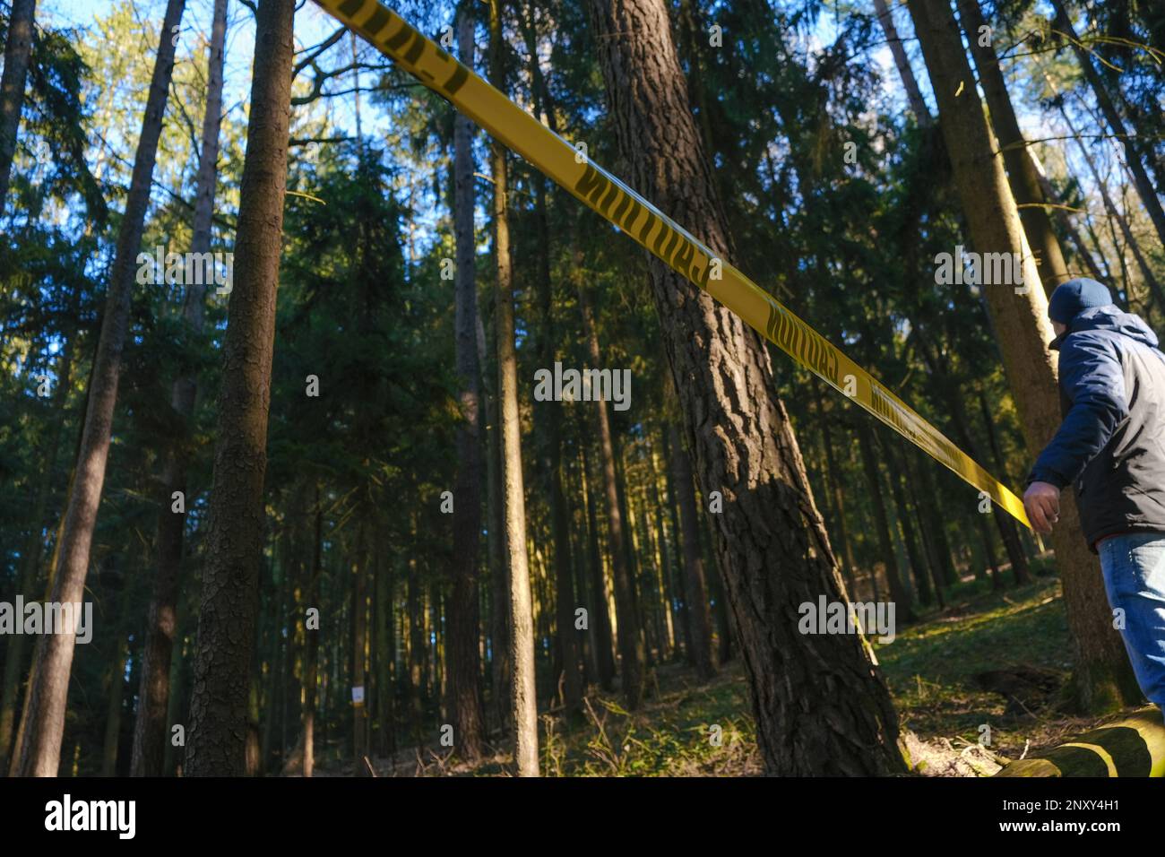 Crime scene. stop motion tape. Entry ban.Man pulling yellow barrier ...