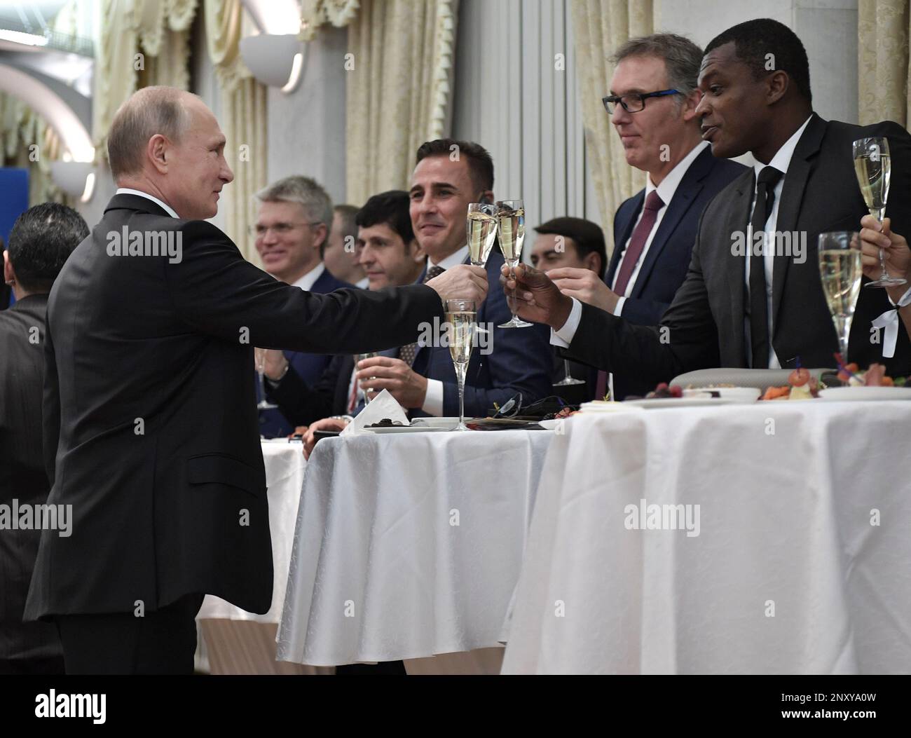 Russian President Vladimir Putin clinks glasses of champaign with ...