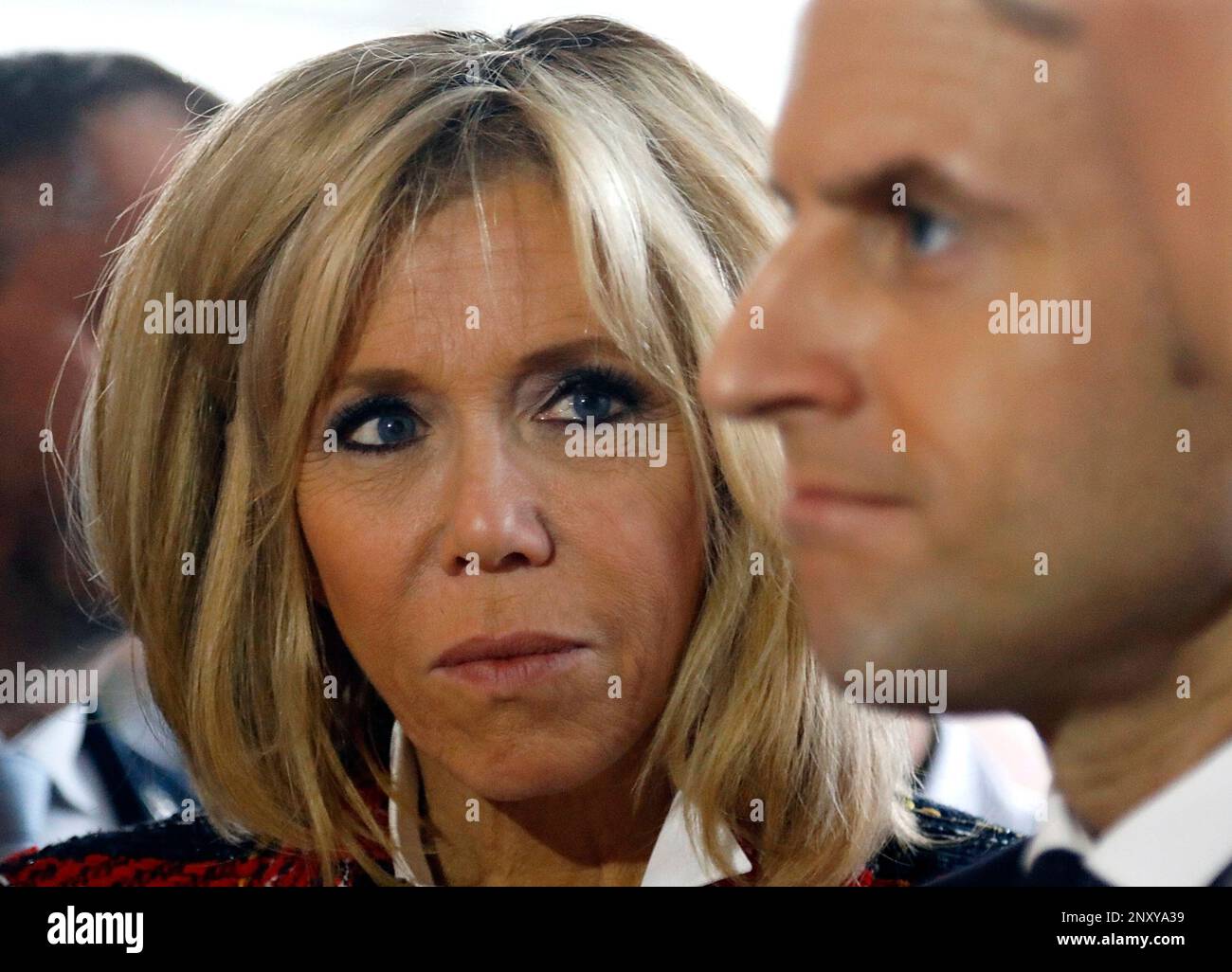 French President Emmanuel Macron and his wife Brigitte talk with ...