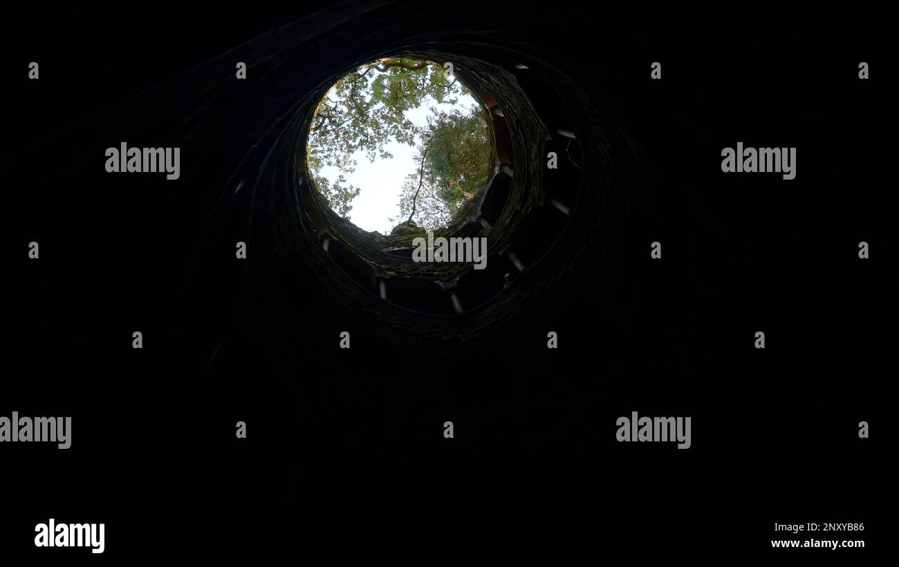 View from the basement. Action. A pipe that goes underground and green ...