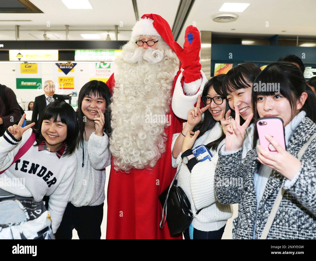 Finland's Santa Clause poses with children after arriving at Narita ...