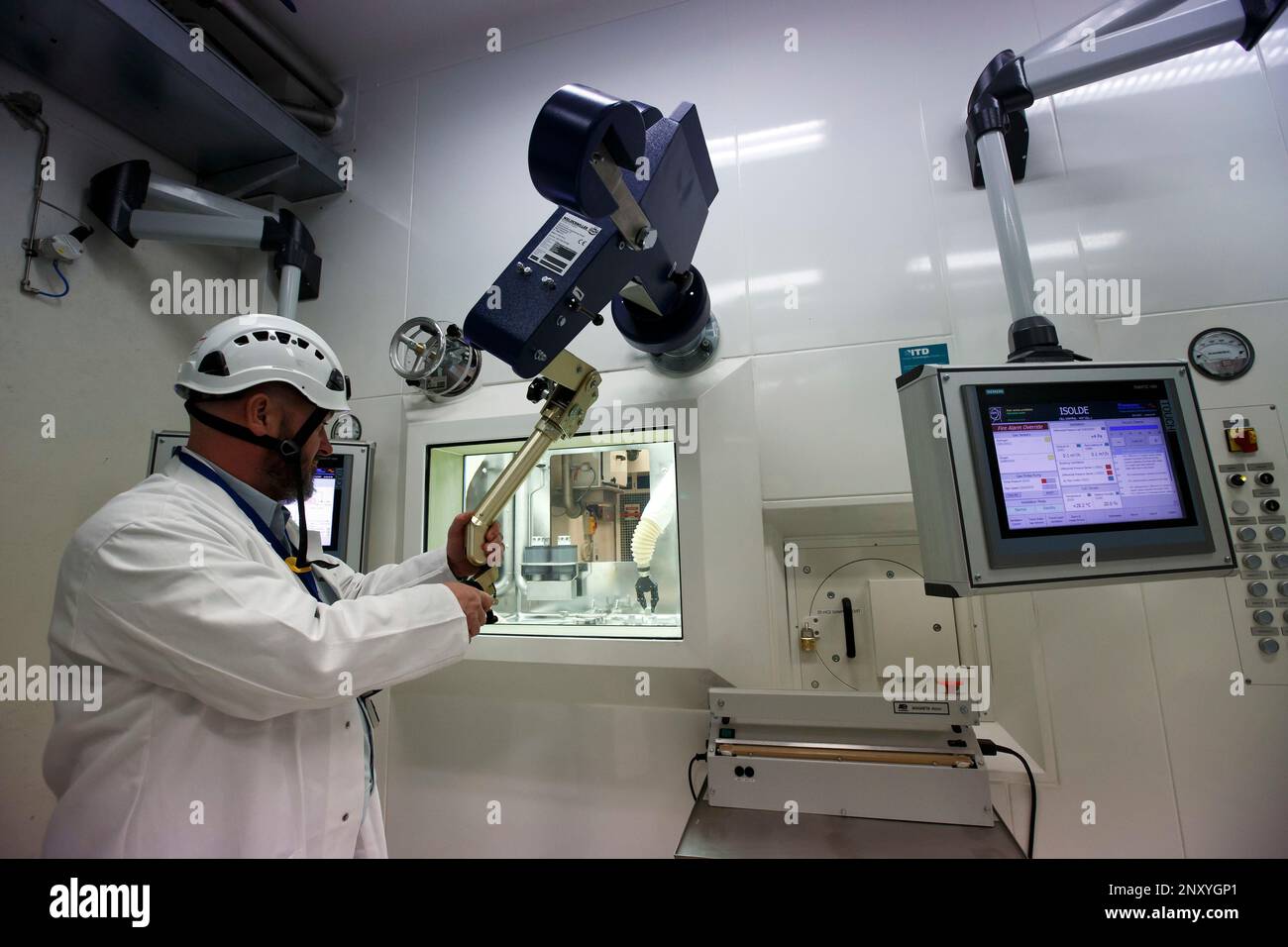 An engineer at CERN makes a demonstration in the hot cell target ...