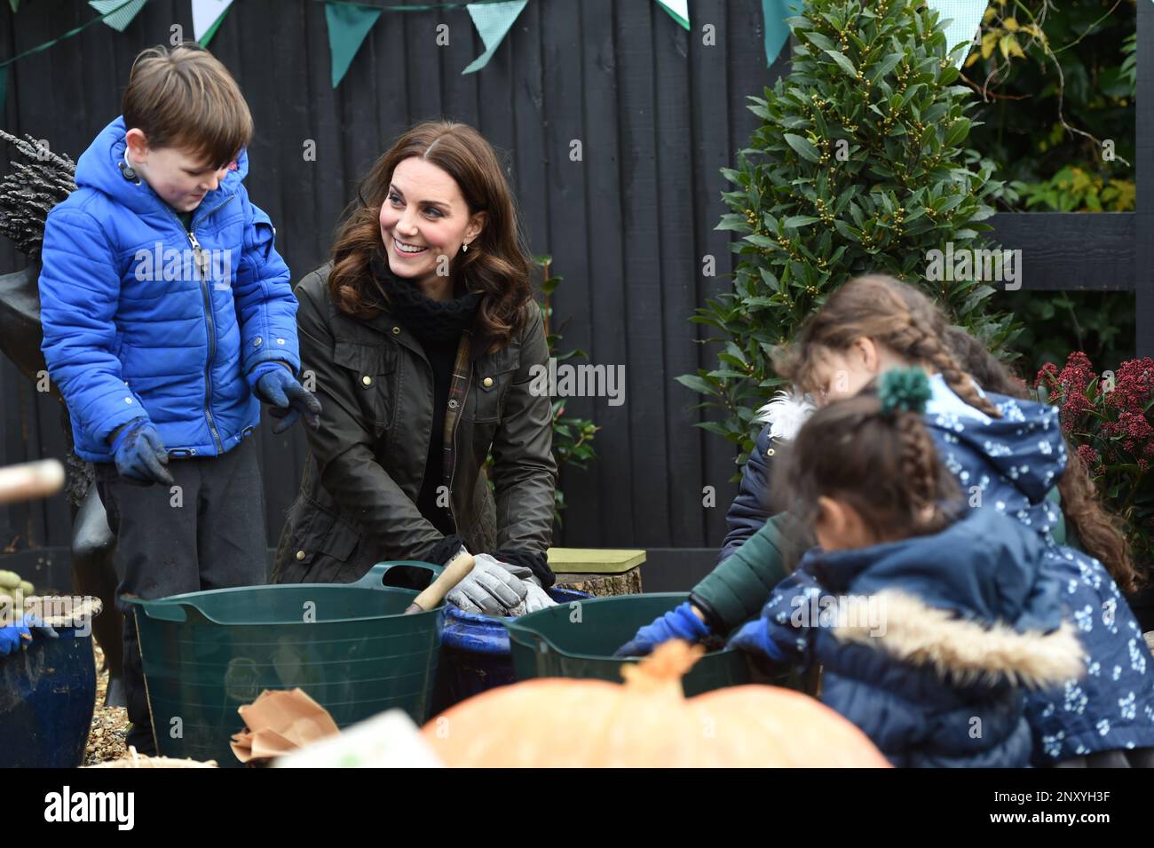 Britain's Kate, the Duchess of Cambridge, talks to children as she ...