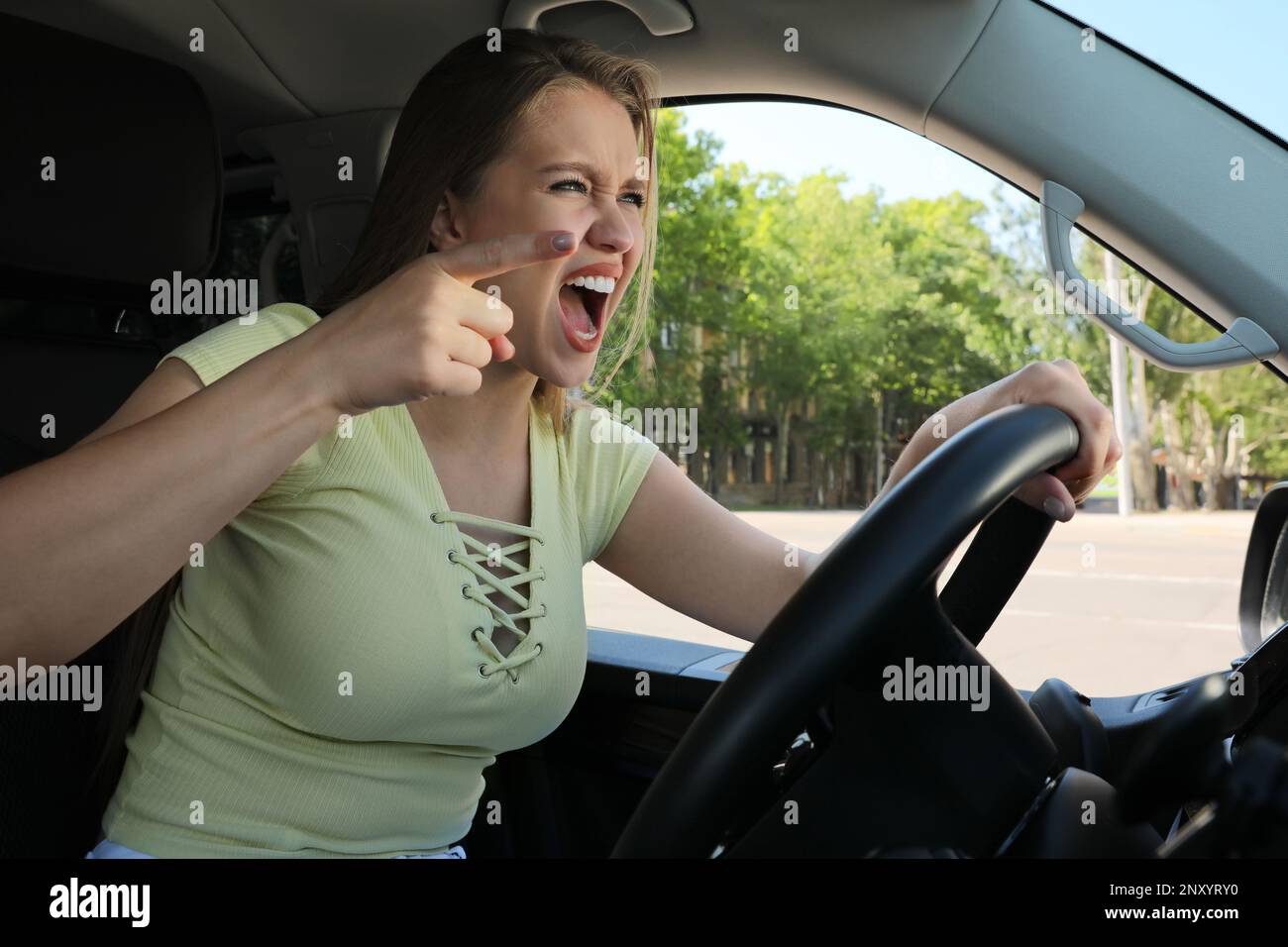 Emotional woman in car. Aggressive driving behavior Stock Photo - Alamy