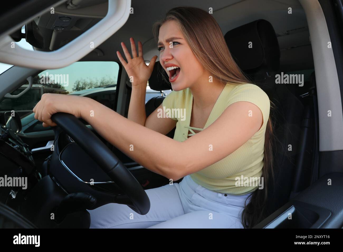 Emotional woman in car. Aggressive driving behavior Stock Photo - Alamy