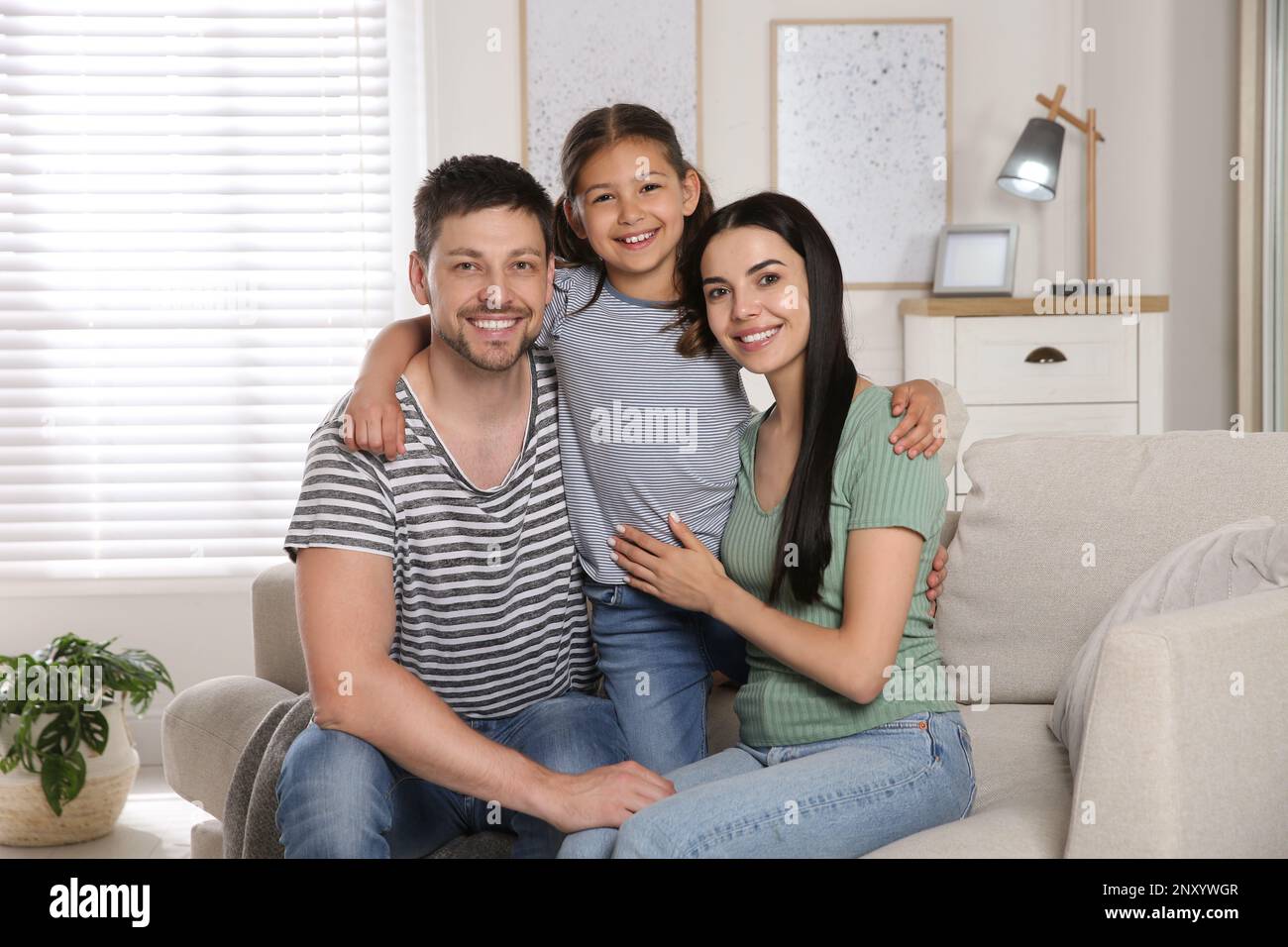 Portrait of happy family in living room. Adoption concept Stock Photo ...