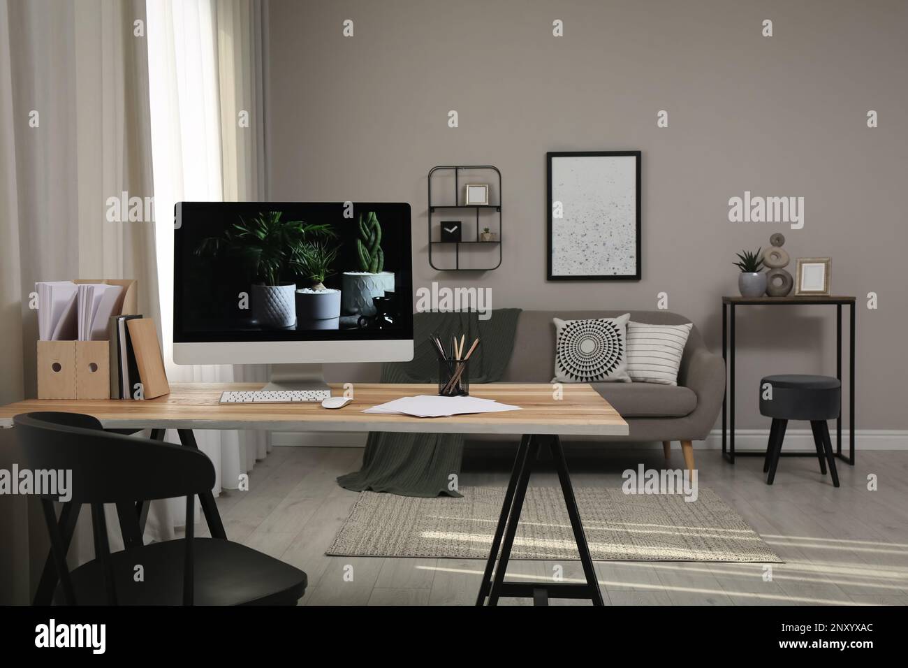 Comfortable workplace with computer on wooden desk in modern office ...