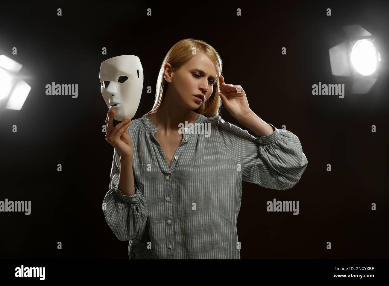 Professional actress rehearsing with mask on stage in theatre Stock ...