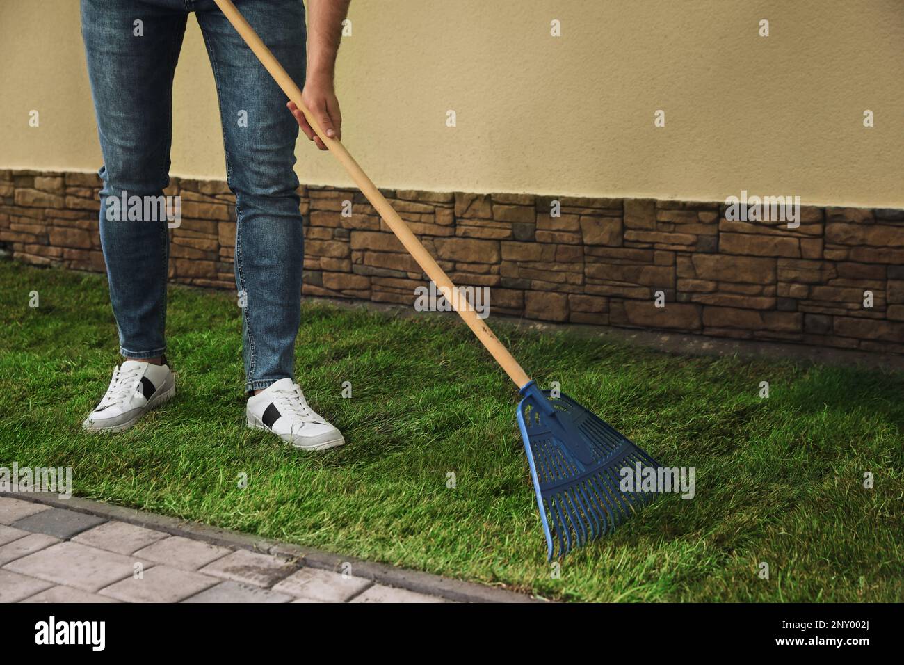 Male raking grass hi-res stock photography and images - Alamy