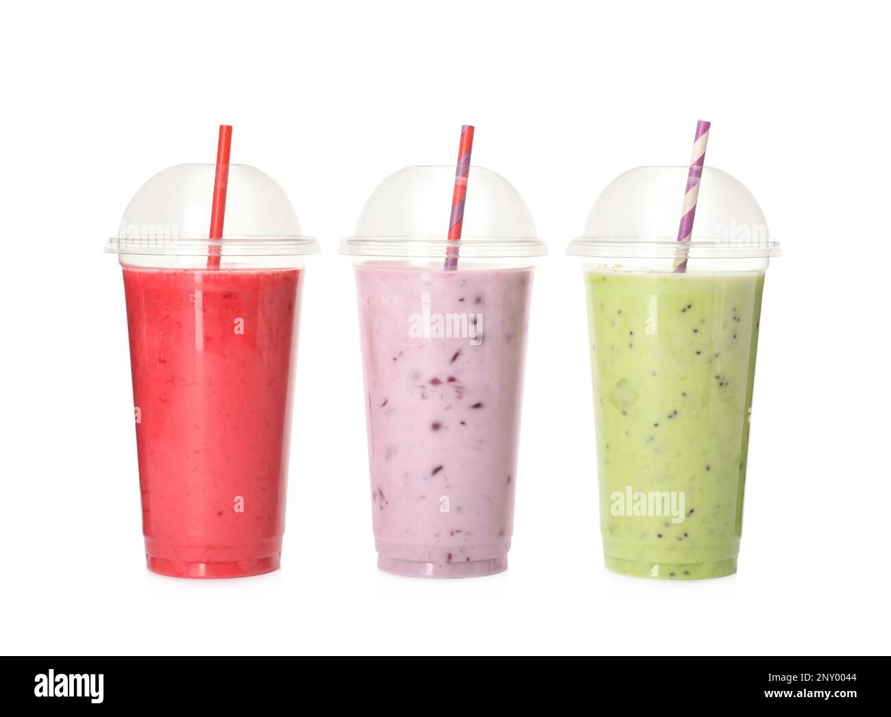 Different smoothies with straws in plastic cups on white background ...