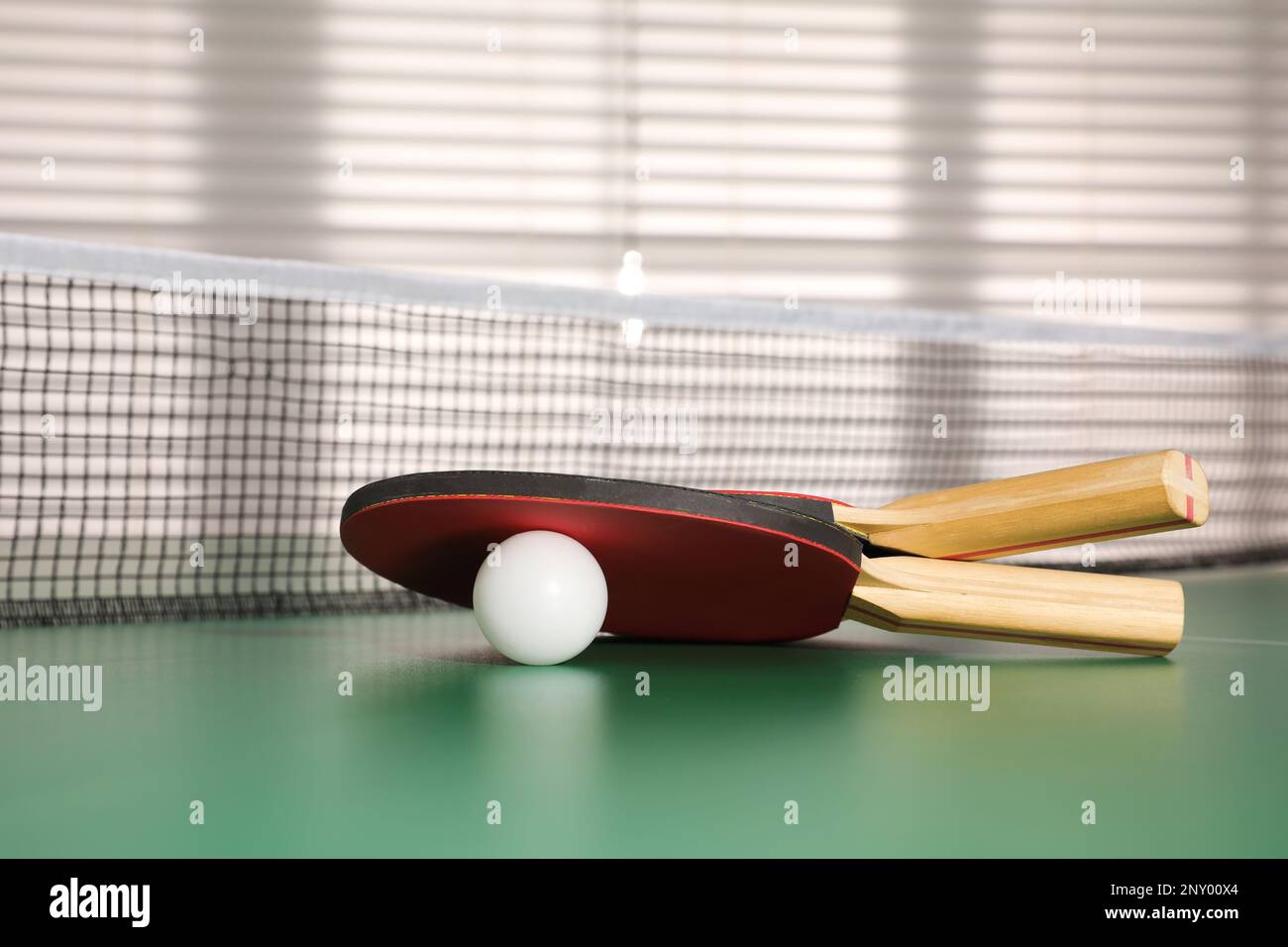 Rackets and ball on ping pong table indoors Stock Photo - Alamy