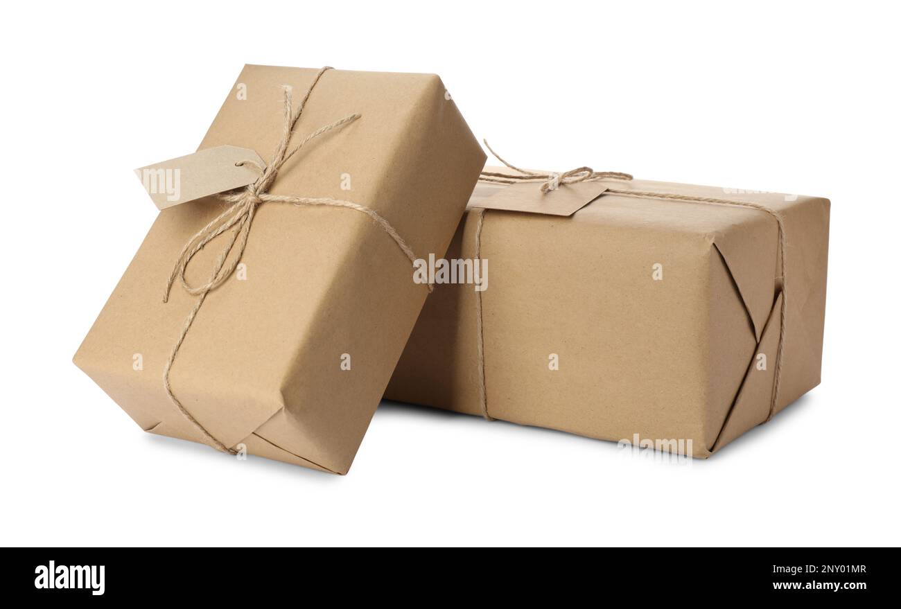 Parcels wrapped in kraft paper with tags on white background Stock ...