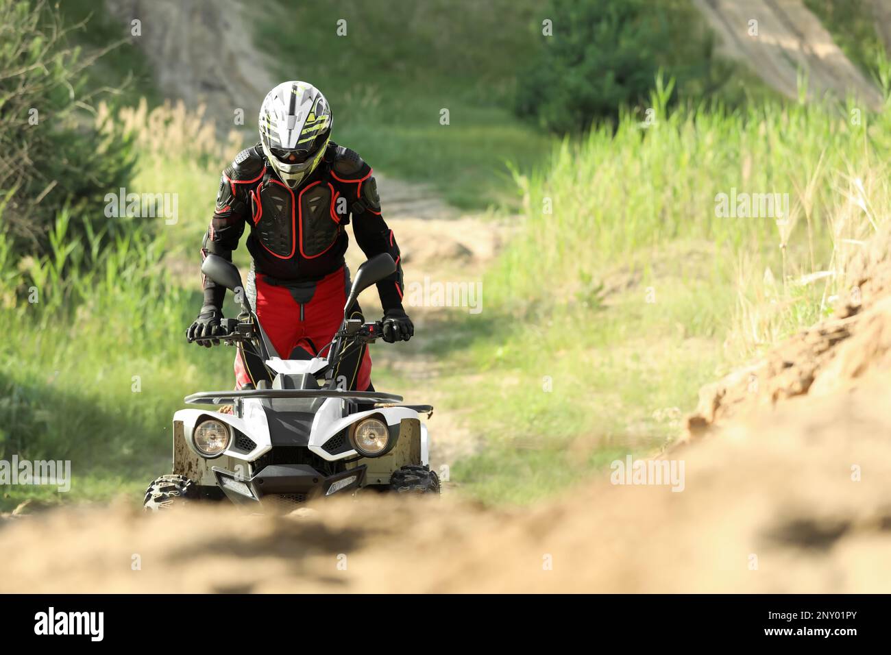 Man driving modern quad bike on sandy road. Extreme sport Stock Photo ...