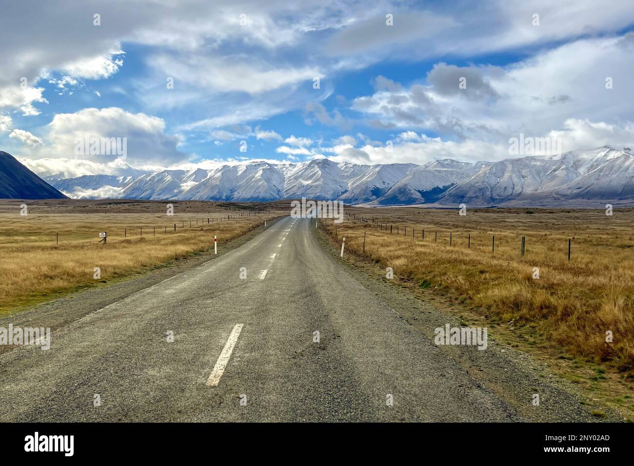 The long country road winding its way through the grass and tussock ...