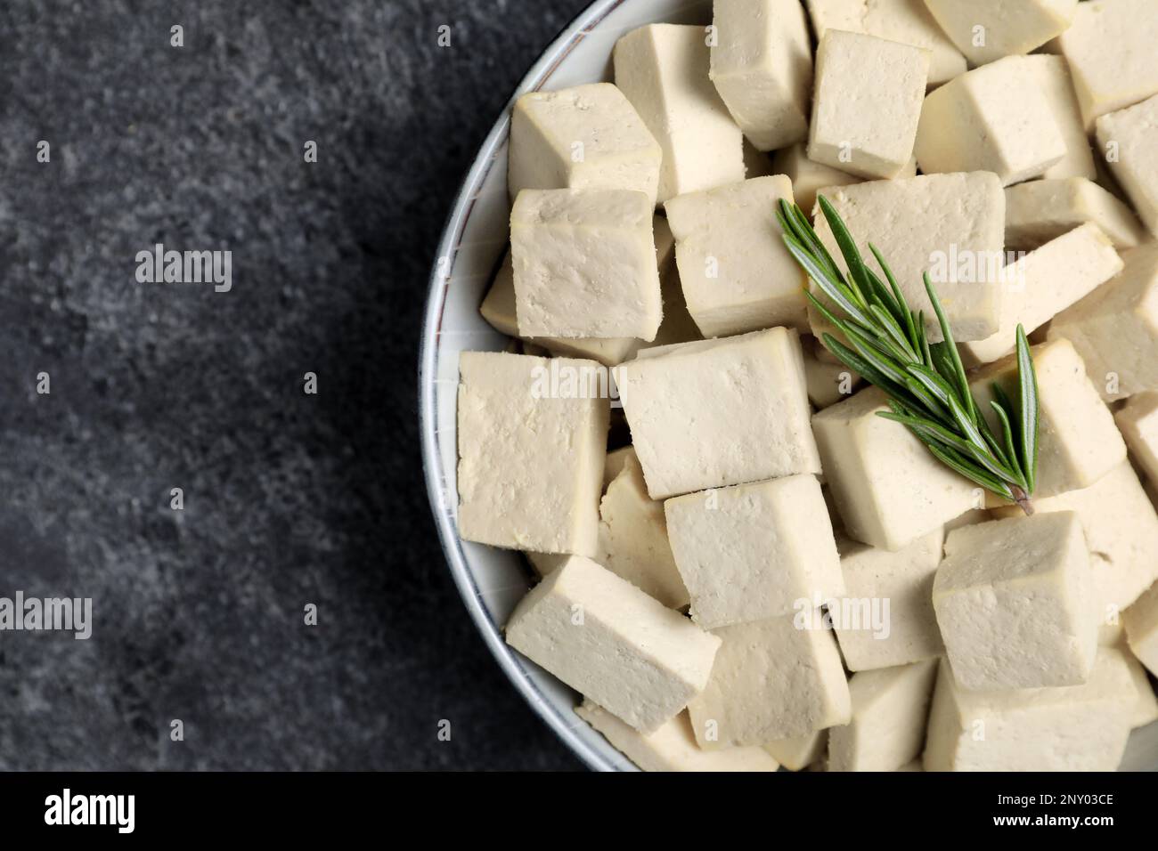Delicious tofu with rosemary on grey table, top view Stock Photo - Alamy