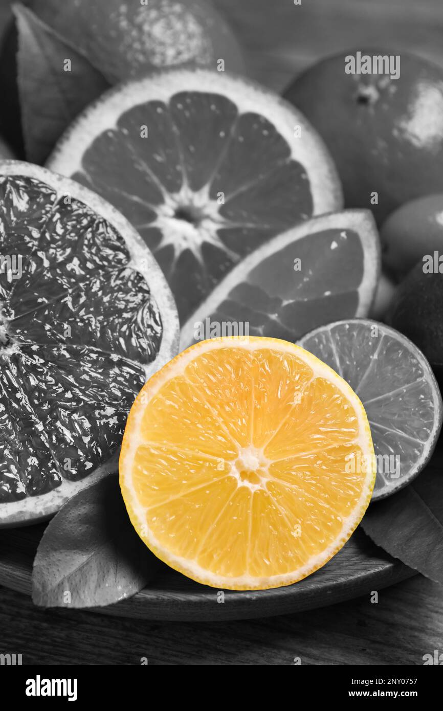 Fresh citrus fruits on plate, closeup. Black and white tone with ...