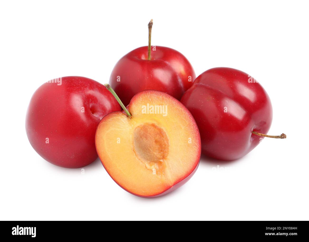 Cut and whole cherry plums on white background Stock Photo - Alamy