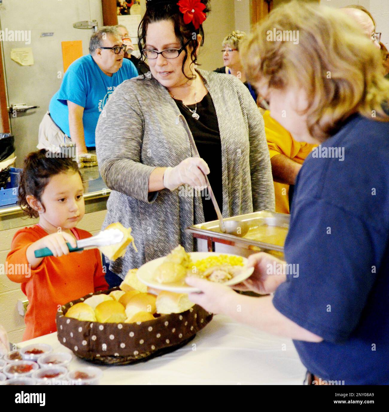 Emma Maki, 5, and her mother Jennifer Maki serve food on Thursday, Nov ...