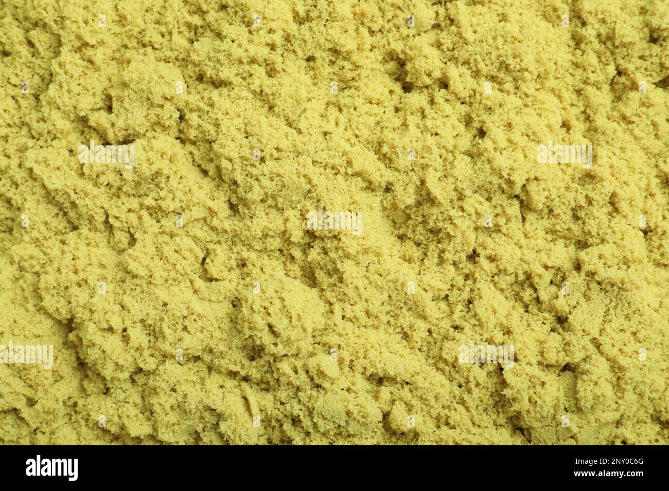 Yellow kinetic sand as background, closeup view Stock Photo - Alamy