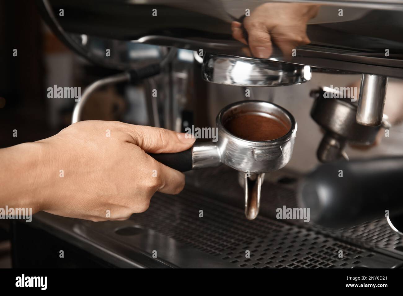Barista making espresso using professional coffee machine, closeup ...