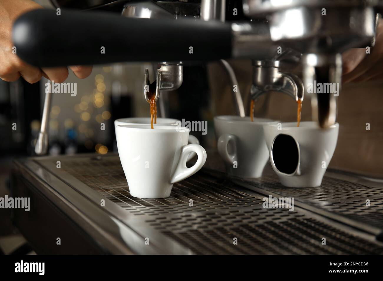 Barista making espresso using professional coffee machine, closeup ...