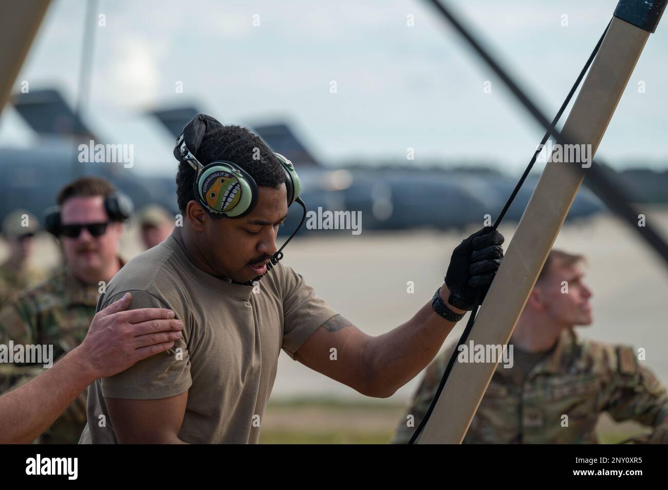 A U.S. Air Force Airman helps set up a mobile command and control point ...