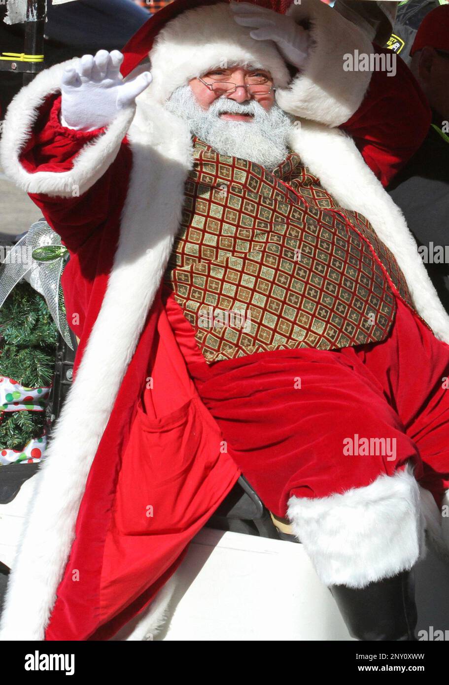Santa Claus waves to the crowd awaiting to greet him after his arrival ...