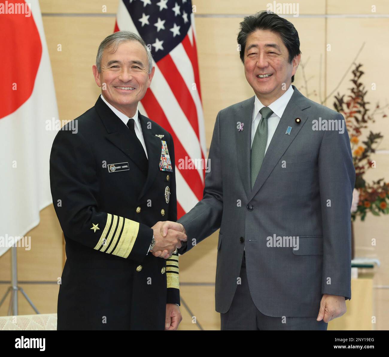Japan's Prime Minister Shinzo Abe(R) shakes hands with Adm. Harry ...