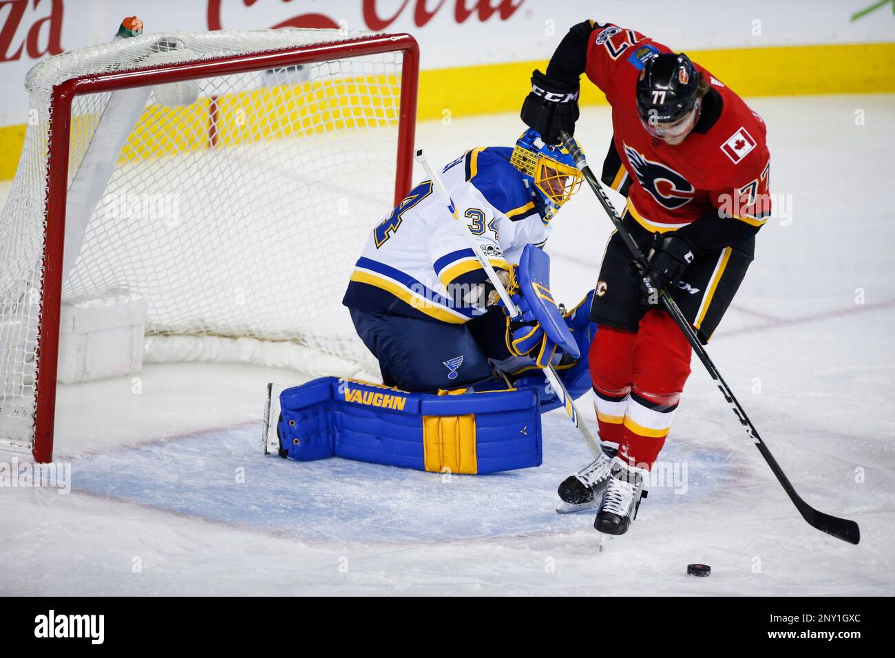 St. Louis Blues goalie Jake Allen, left, watches as Calgary Flames ...
