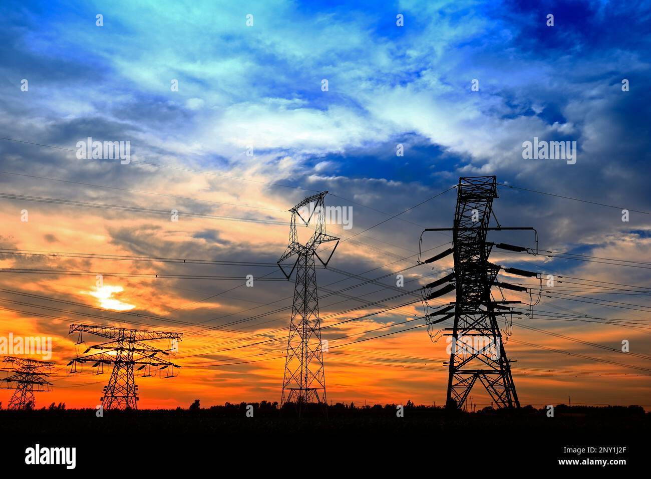 Pylon, high-voltage tower sky background Stock Photo - Alamy