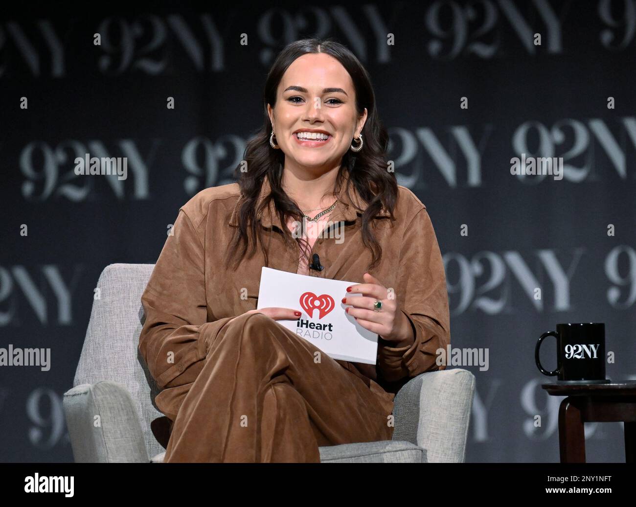 Moderator Emily Curl speaking on stage about the Netflix television ...