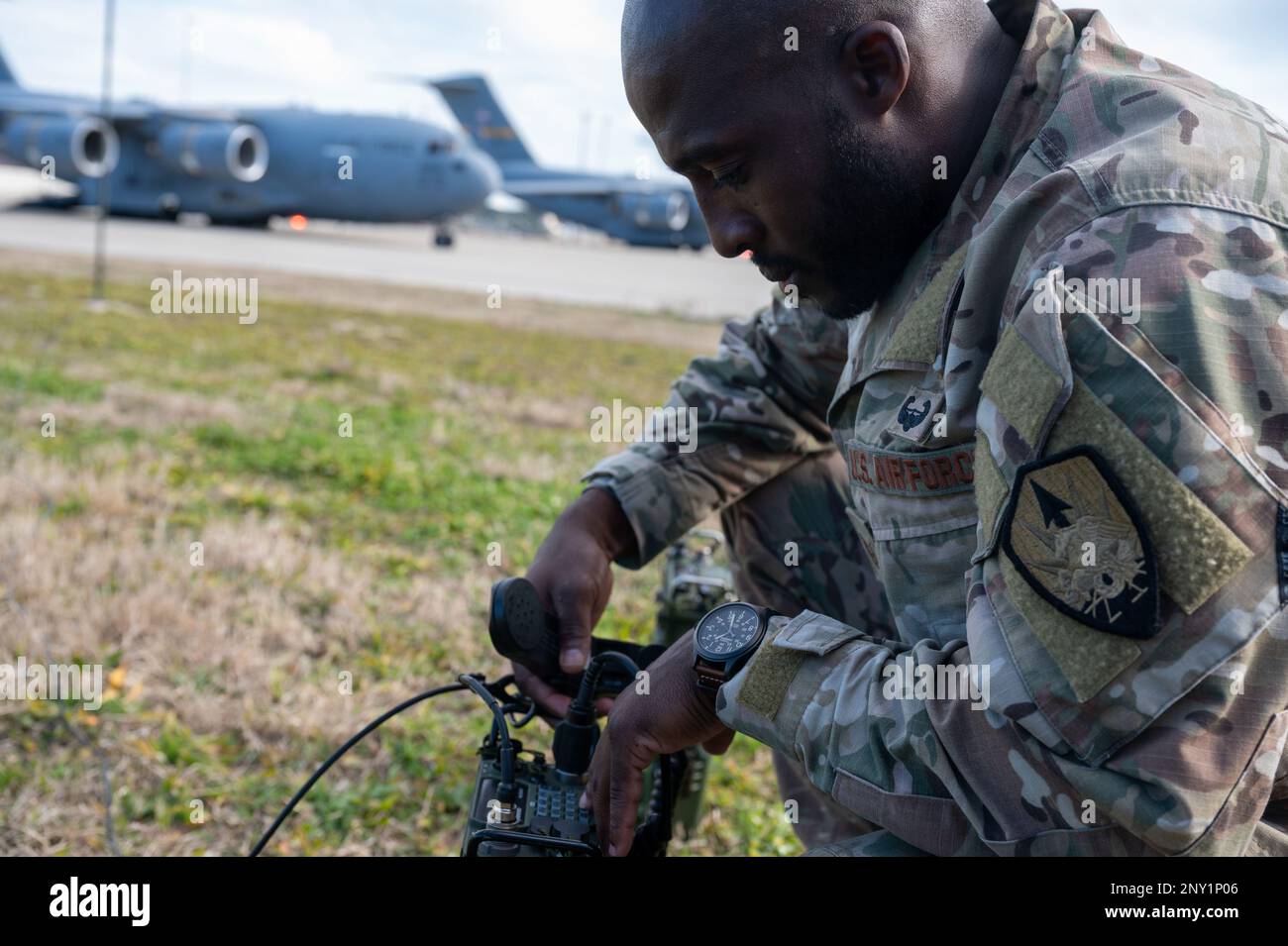 A U.S. Air Force Airman sets up a mobile communications antenna for a ...