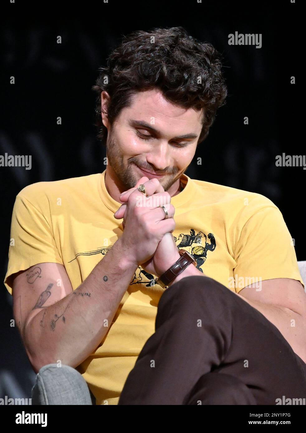 Actor Chase Stokes speaking on stage about the Netflix television ...