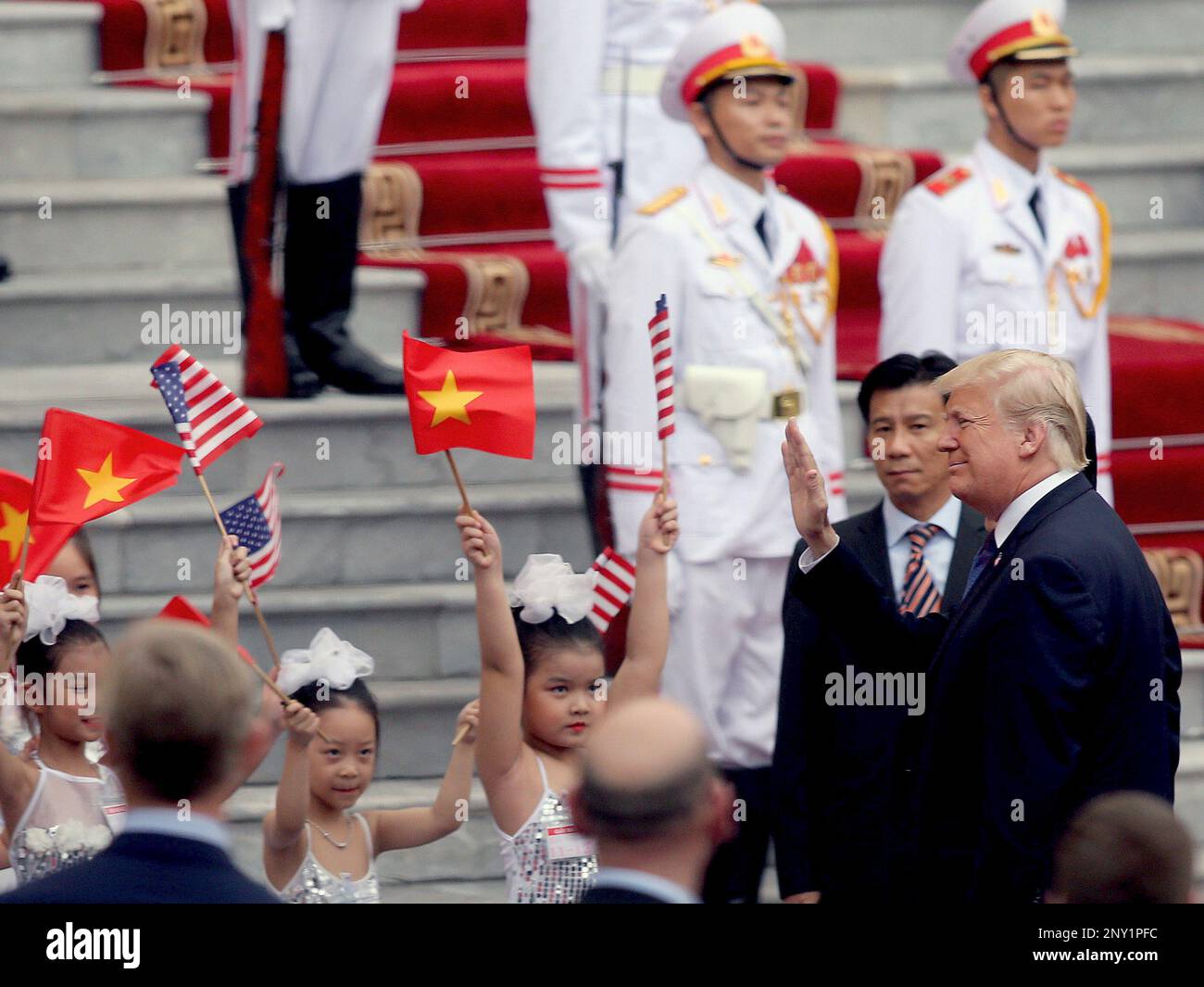 U.S. President Donald Trump, right, waves to Vietnamese children during ...