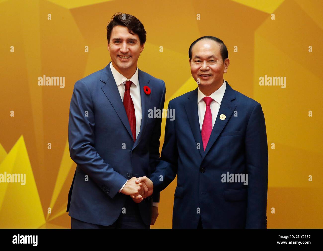 Vietnam's President Tran Dai Quang, right, shakes hands with Canada's ...