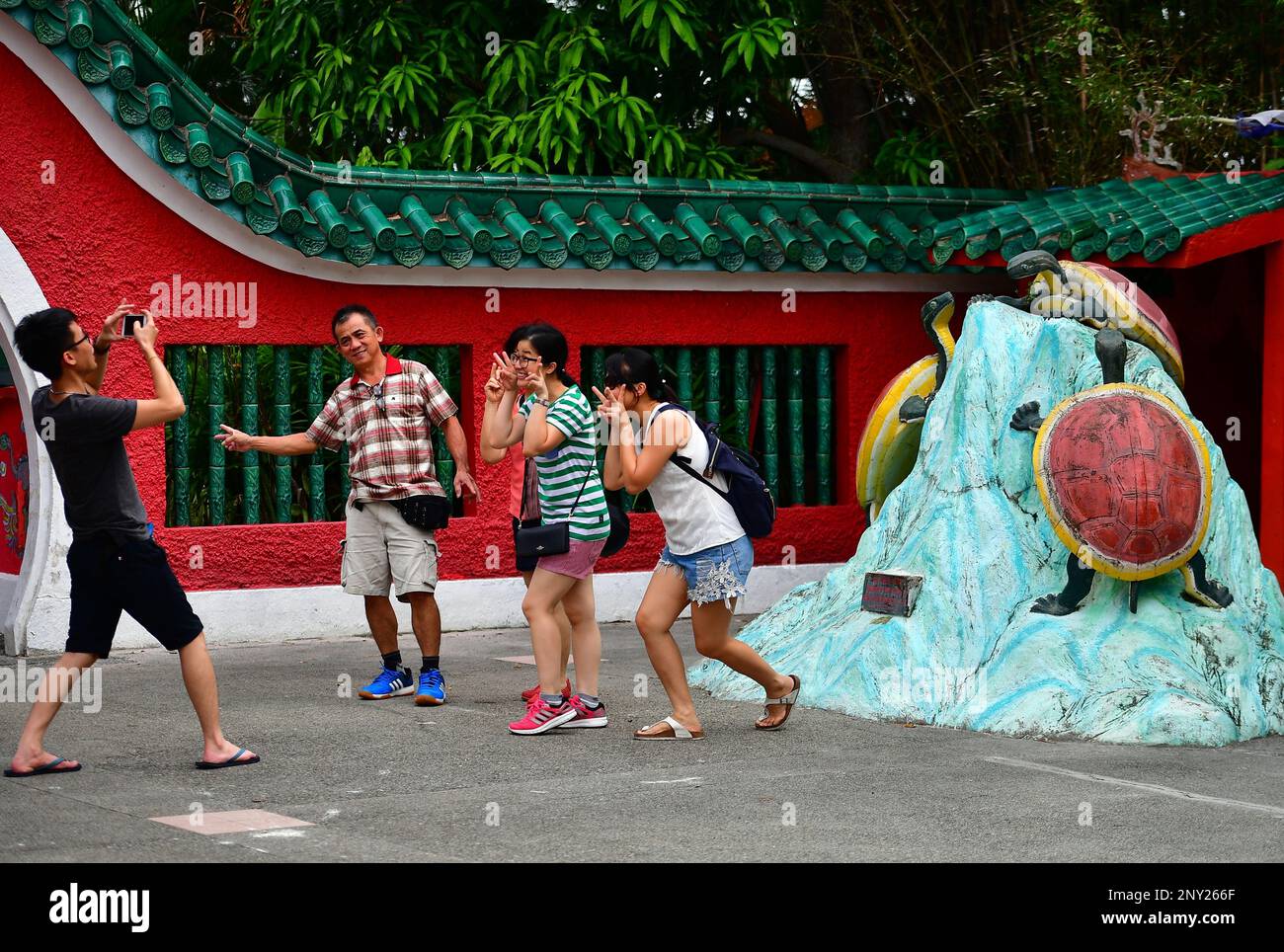 Devotees taking photographs at the Da Bo Gong temple at Kusu Island ...