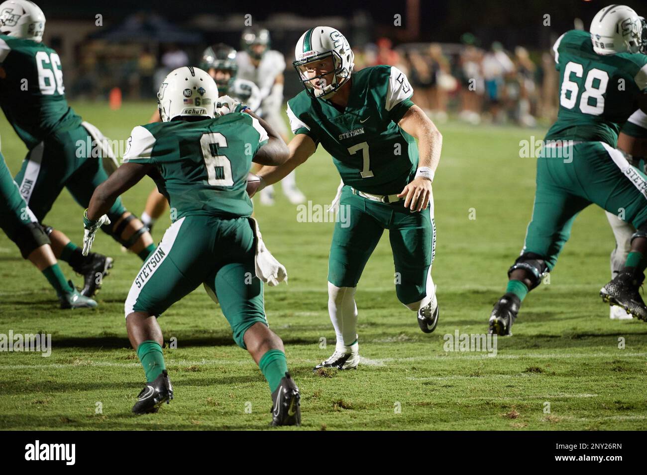 Stetson Hatters quarterback Colin McGovern (7) hands off to running ...