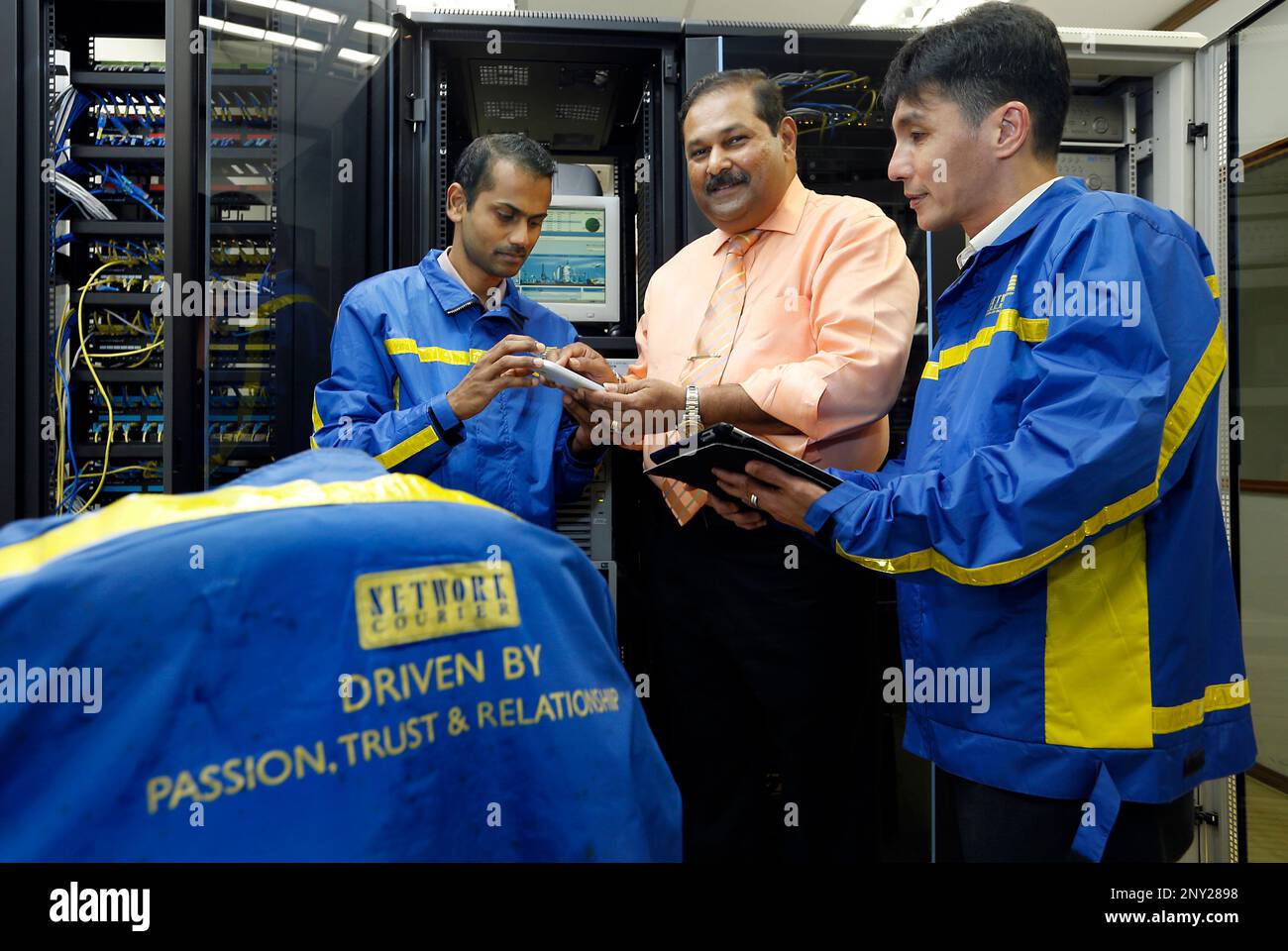Managing director of Network Courier, Mr VS Kumar (centre), with two of ...