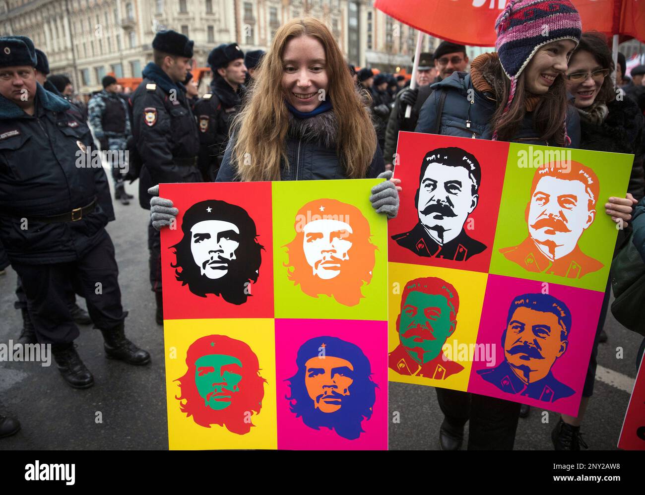 Communist party supporters carry Andy Warhol-style portraits of Cuban ...