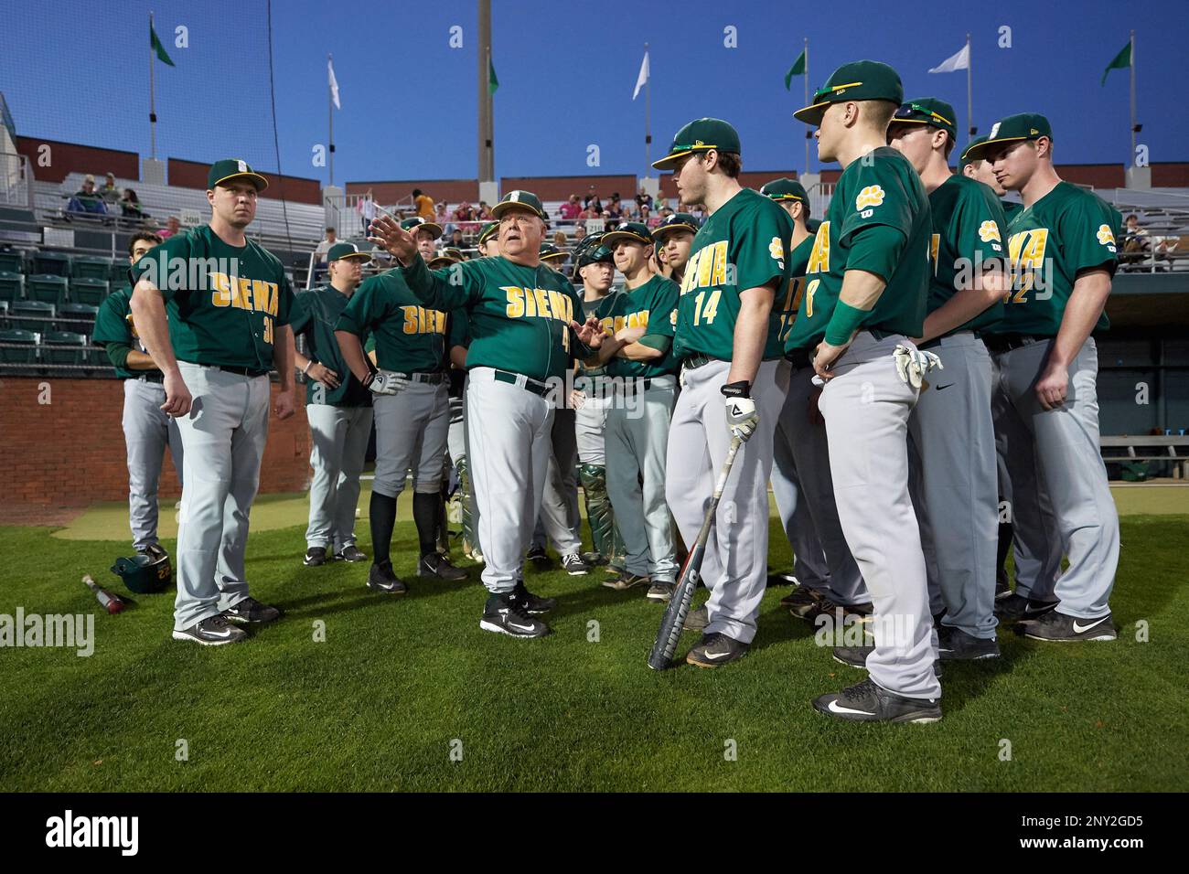 Siena Saints head coach Tony Rossi (40) goes over the ground rules with ...