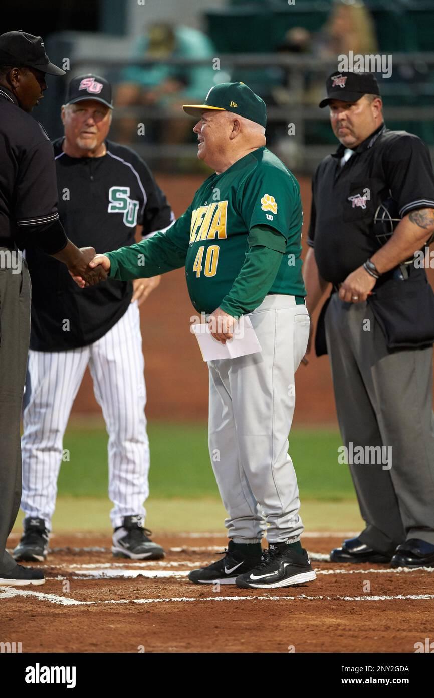 Siena Saints head coach Tony Rossi (40) shakes hands with third base ...
