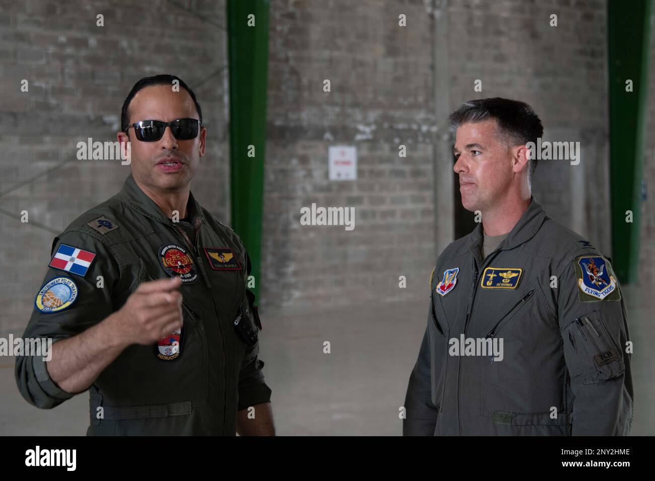 A Fuerza Aérea de República Dominicana officer, left, discusses ...
