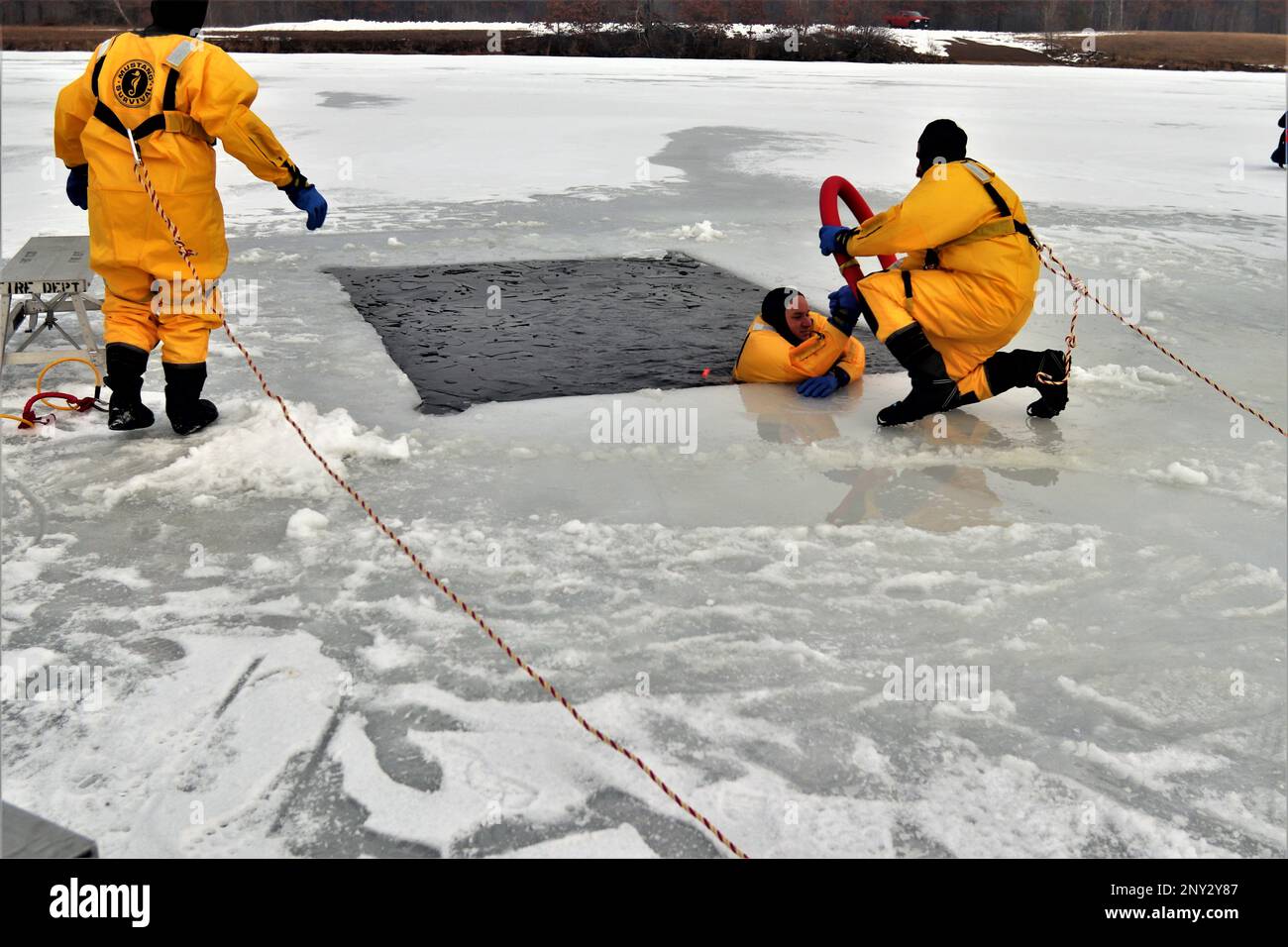Firefighters wearing cold-water immersion protective suits hold surface ...