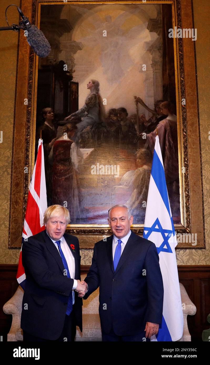 Britain's Foreign Secretary Boris Johnson, left, shakes hands with ...