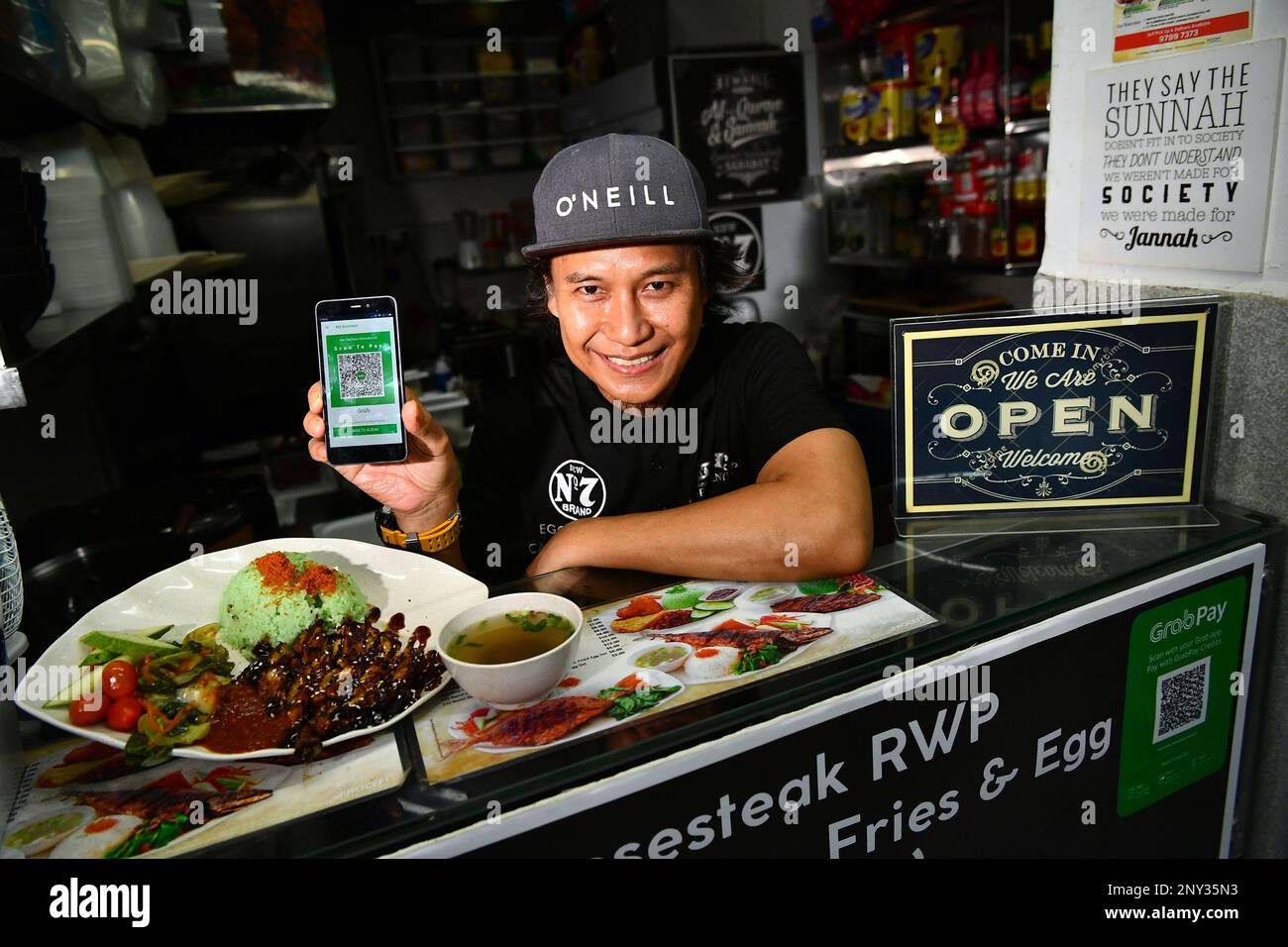 Mr Nornizam Bin Amin, 46, Owner of Rayyan's Waroeng Penyet, with the QR ...