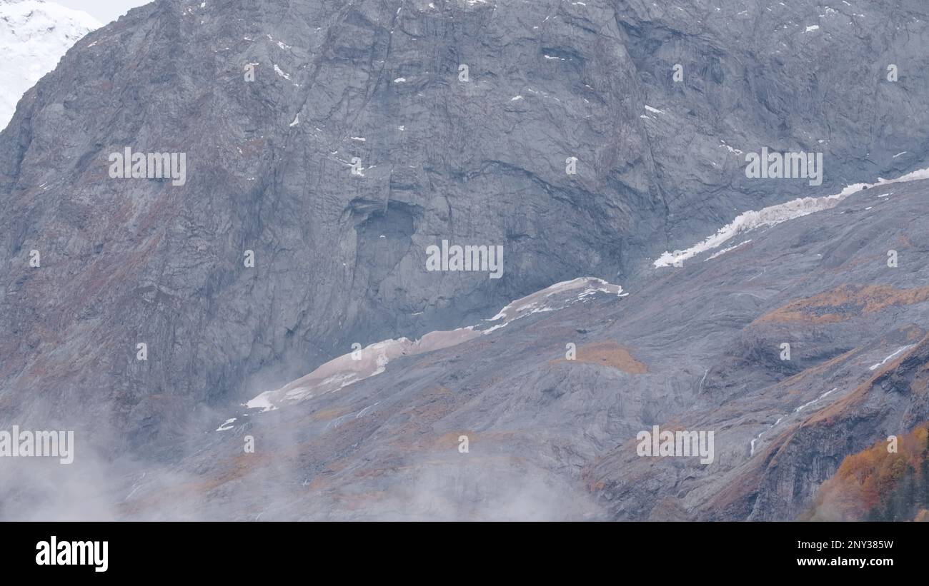 Huge mountains standing under a white fog. Creative. Large yellow and ...