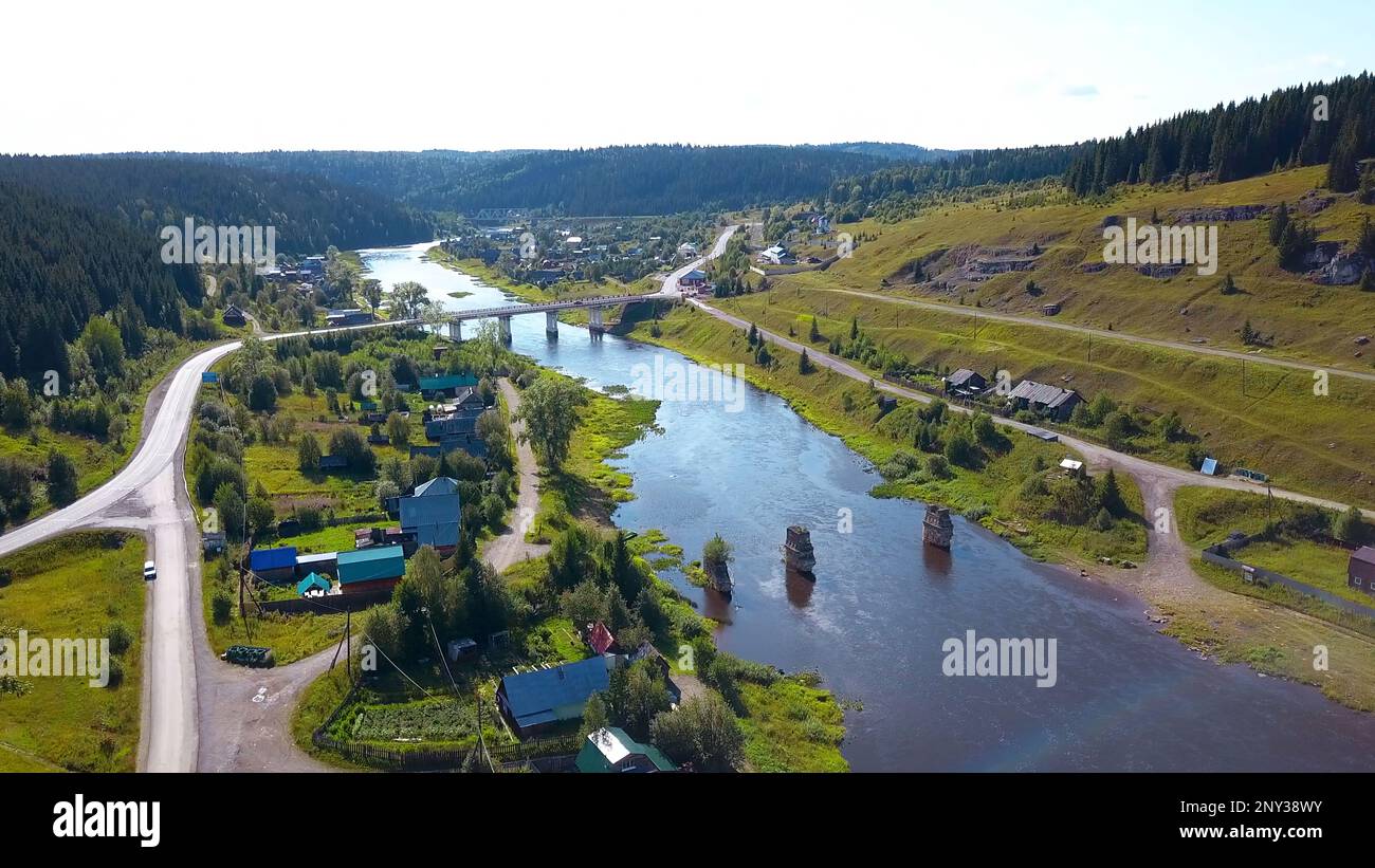 Top view of village and old bridge over river. Clip. Beautiful ...