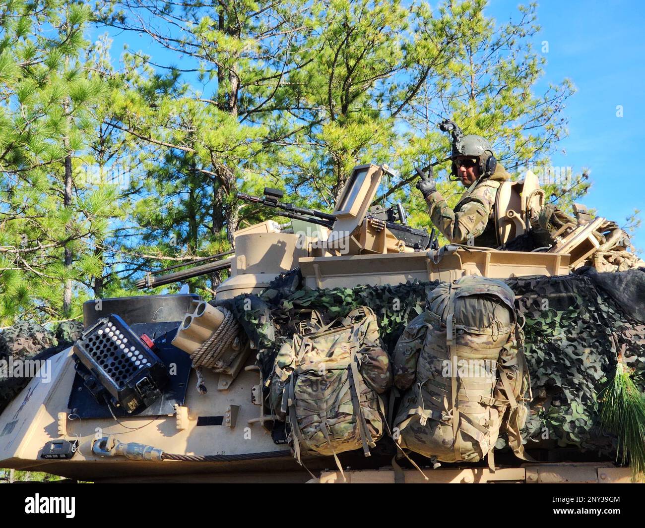 An M1 Abrams tank crewmember seated in the turret during training box ...