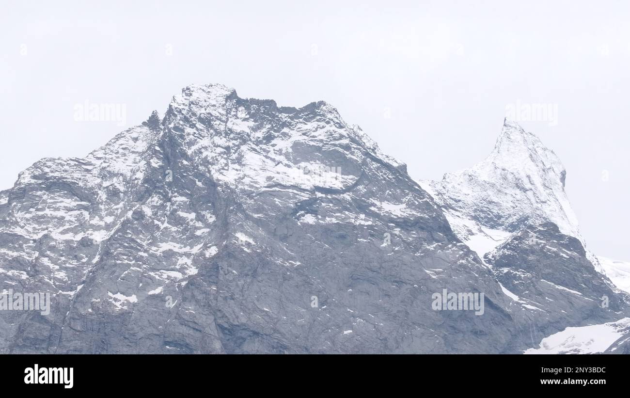 Huge mountains standing under a white fog. Creative. Large yellow and ...