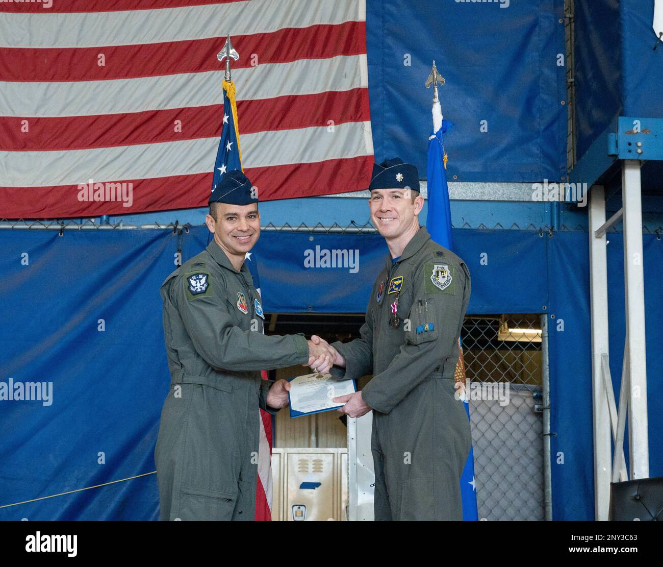 Col. Michael Alfaro, 4th Operations Group commander, presents the Meritorious Service Medal to ...